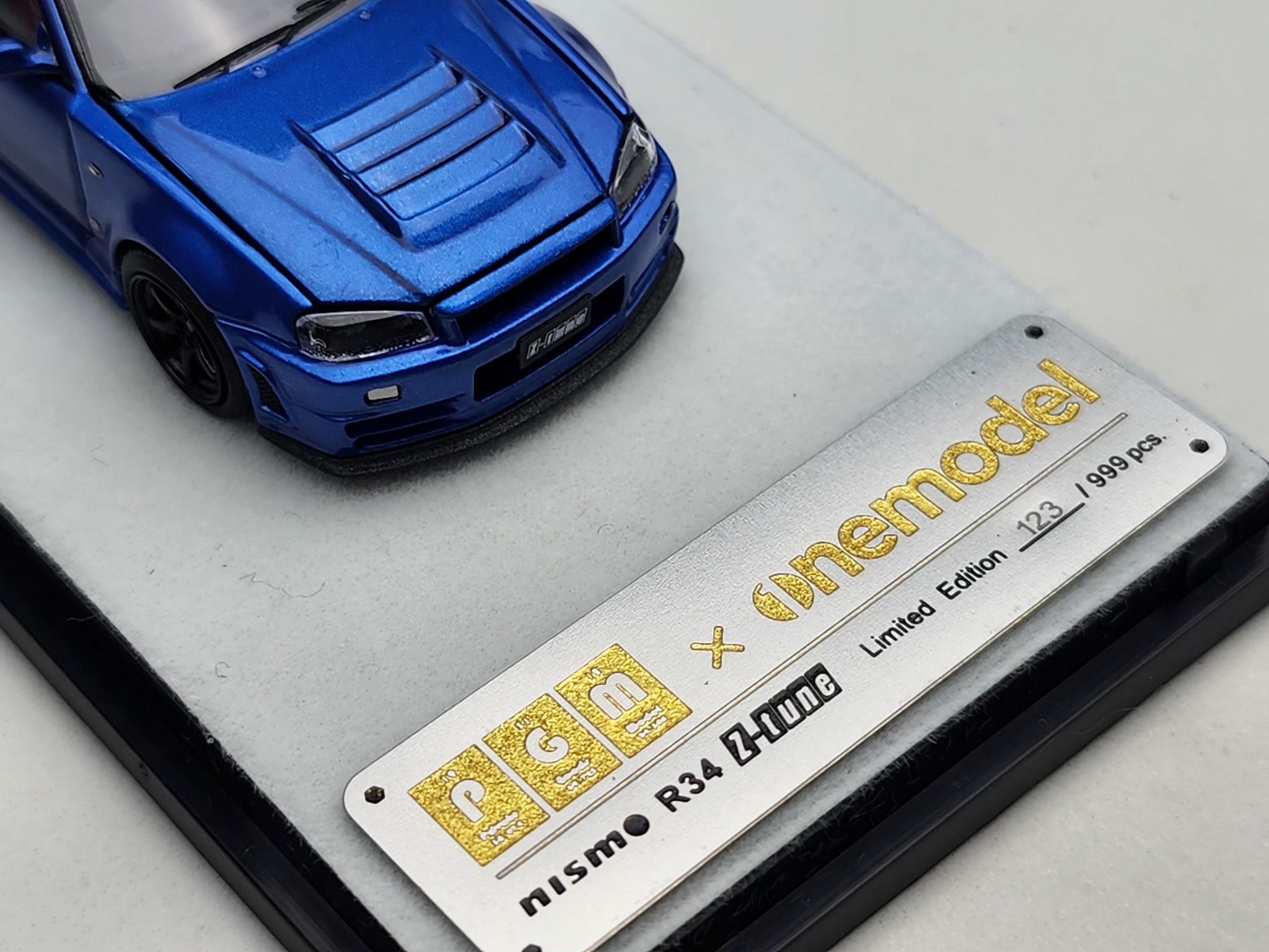 Xe Mô Hình Nissan R34 Z Tune " Vuông" 1:64 PGM*One Model ( Metallic Bl ...